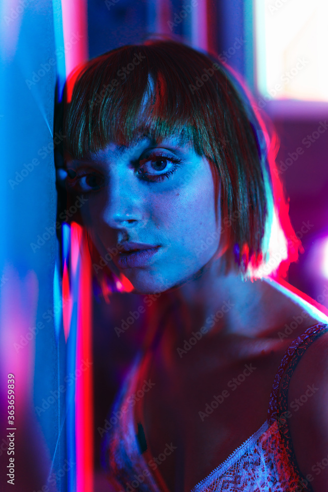 Beautiful female model with red and blue lights on her skin Stock Photo ...