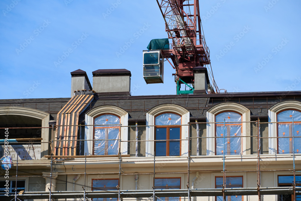 modern building under construction, plastered walls and scaffolding ...
