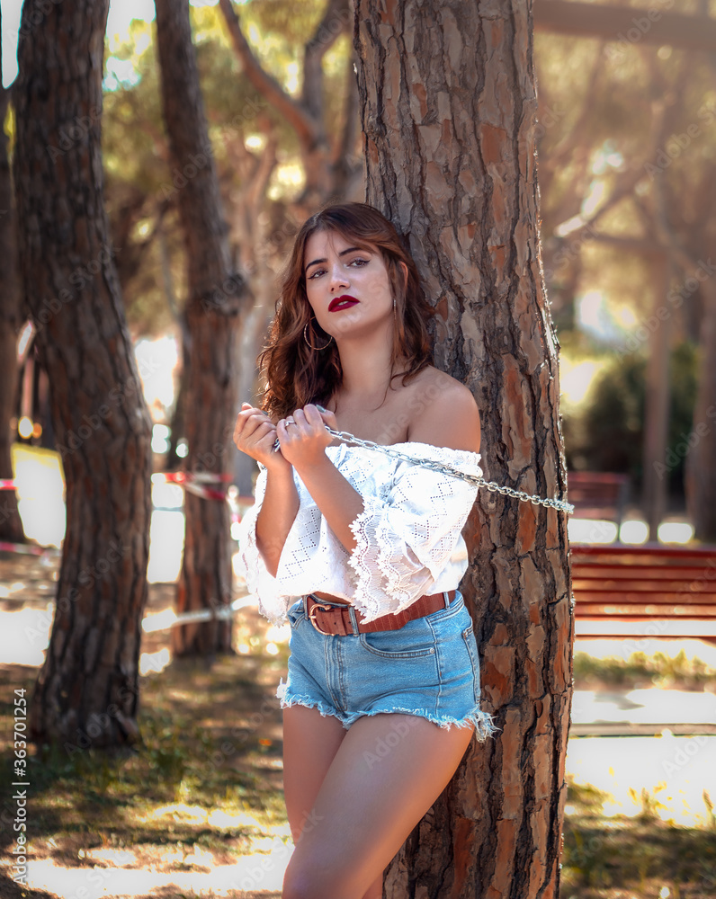 young hippie tied to a tree with chains Stock Photo | Adobe Stock