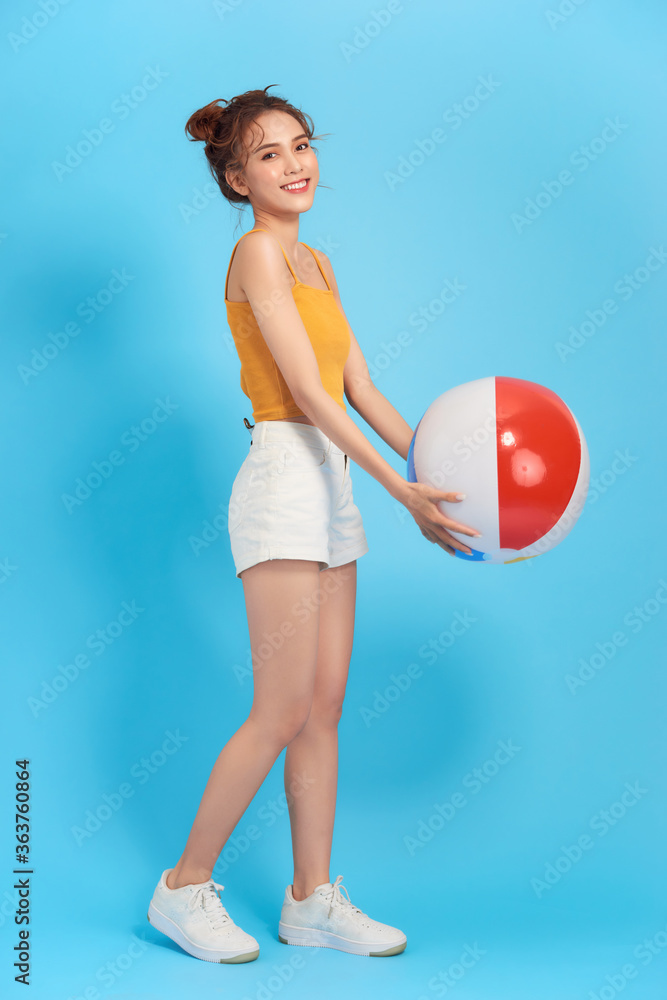 Catching a beach ball. Laughing young woman playing a beach ball Stock ...