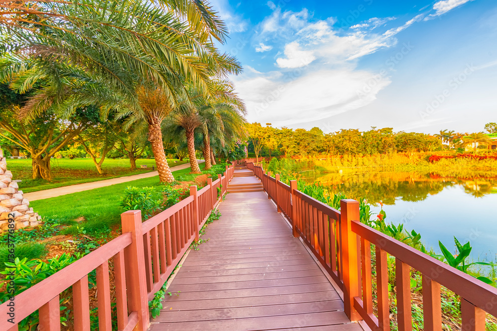 Outdoor park square with brick walkways and wooden paths at sunrise and ...