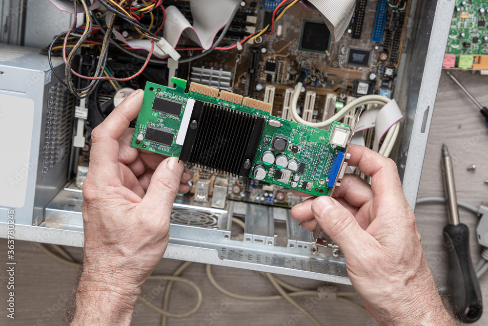 Repairing and assembling a desktop computer. Professional man repairing ...