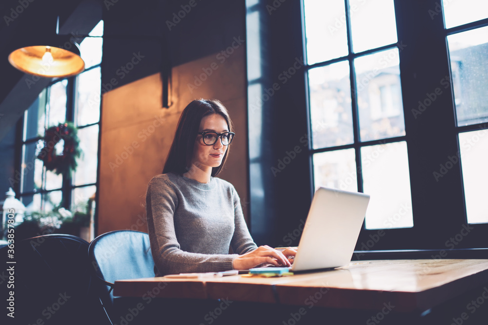 Young charming female IT programmer loading upgraded software into ...