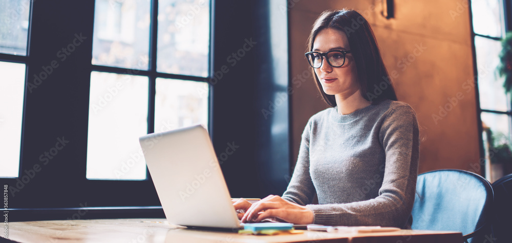 Young charming female IT programmer loading upgraded software into ...