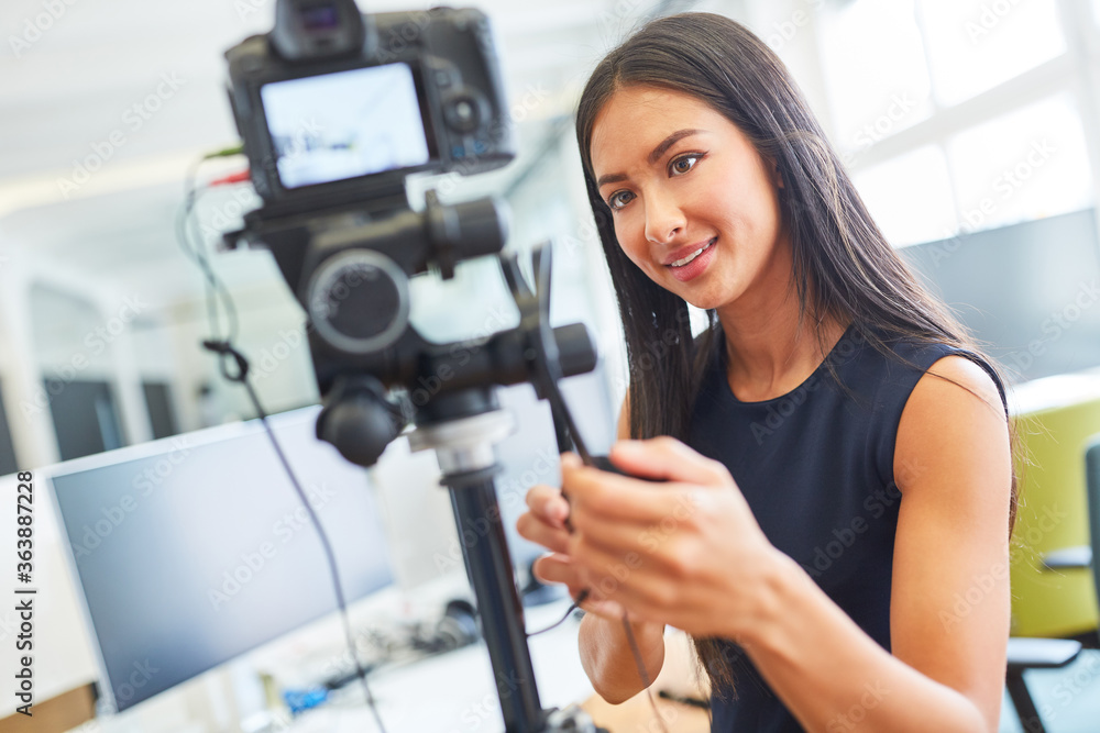 Business woman prepares video camera for a shot Stock Photo | Adobe Stock