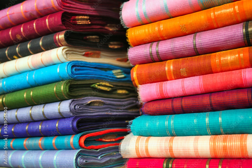 Maheshwari saris in a textile shop, displayed in front of customers ...