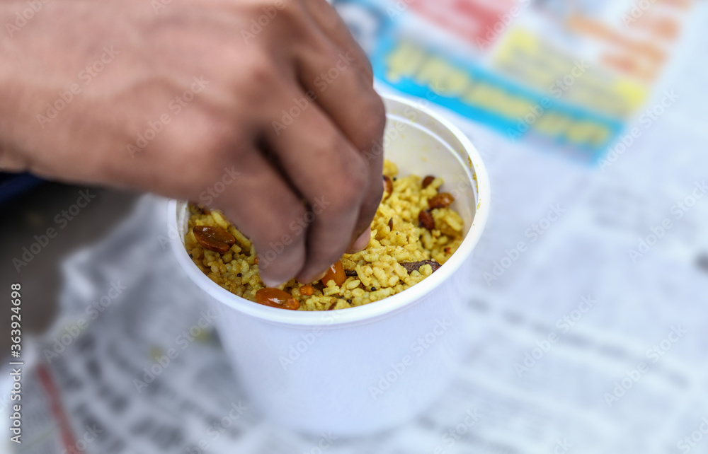 Overhead view of Indian man hand eating Tamarind Rice on ground from ...
