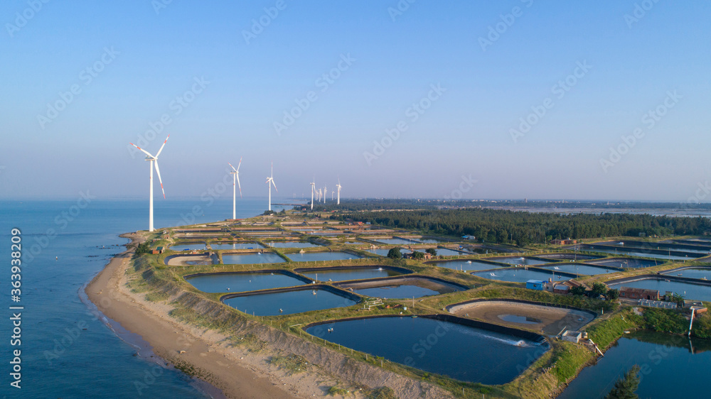 Seaside wind power generation and coastal salt and farming farms. Stock ...