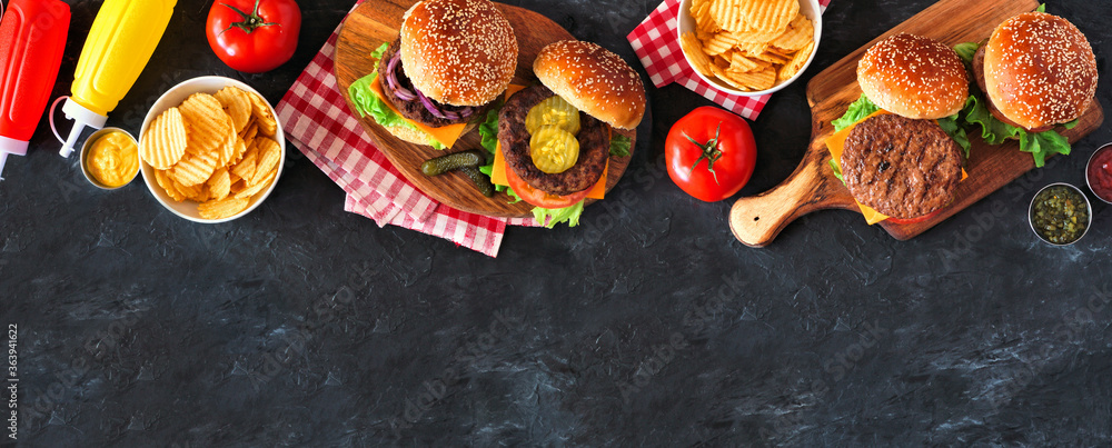 BBQ hamburger top border. Overhead view table scene on a dark slate ...