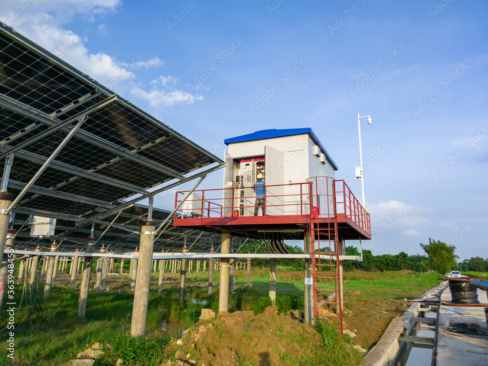 Workers repair and install a transformer system that generates ...