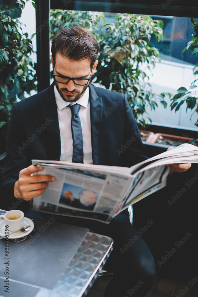 Portrait of young brunette hair businessman sitting in a coffee shop ...