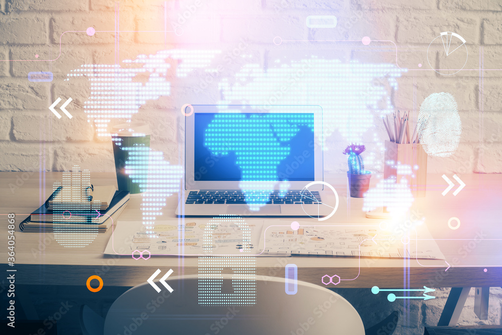 Double exposure of desktop with computer and world map hologram ...