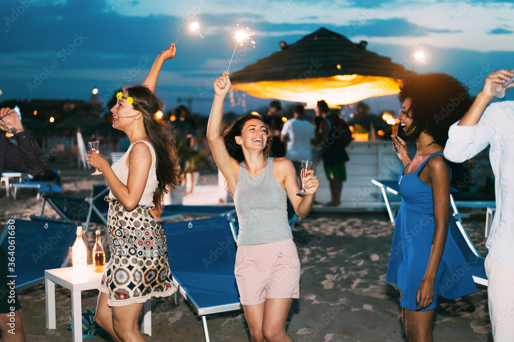 Happy friends having fun beach party outdoor dancing together - Young ...