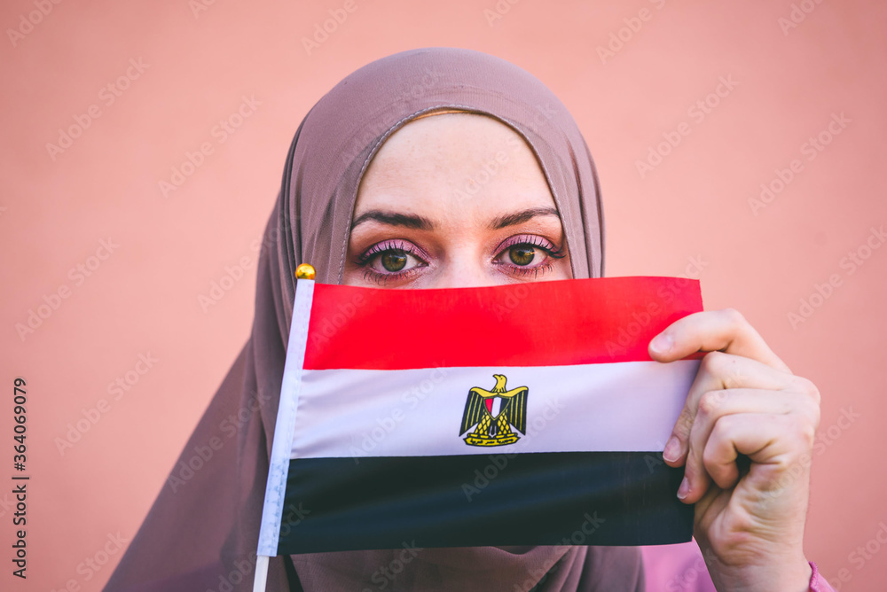 Muslim woman in hijab holds flag of Egypt Stock Photo | Adobe Stock