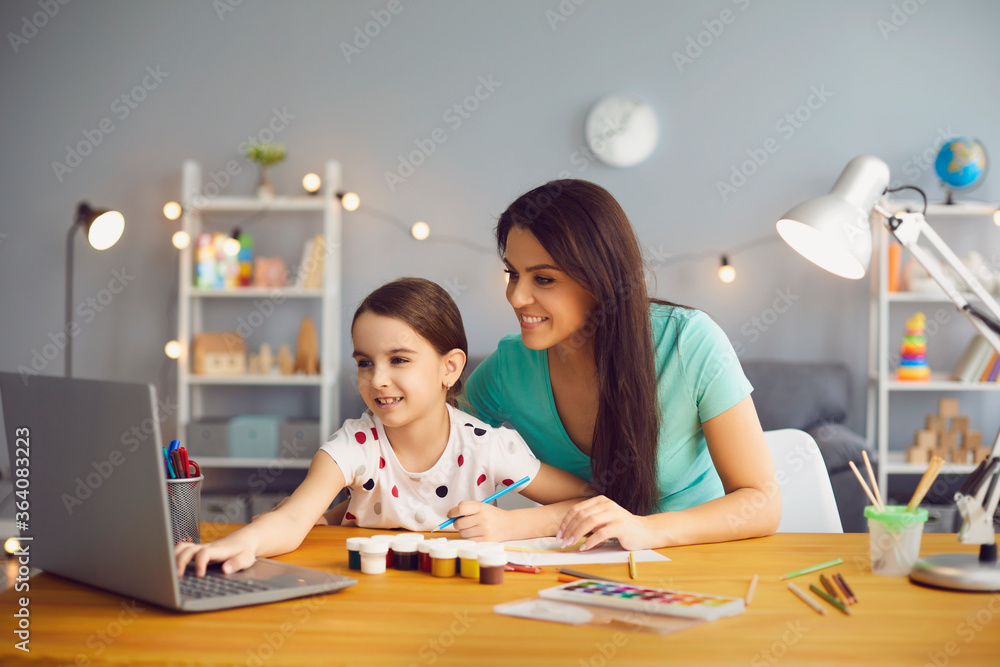 Online training for children. Mother and daughter watching video lesson ...