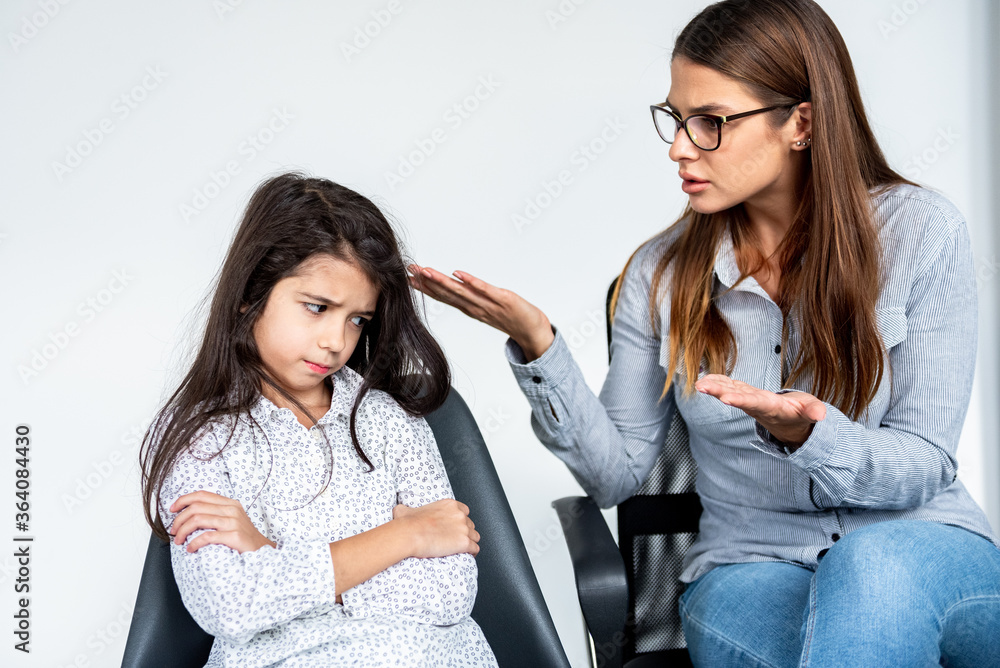 Young strict mother or sister scolding stubborn kid girl. Stock Photo ...