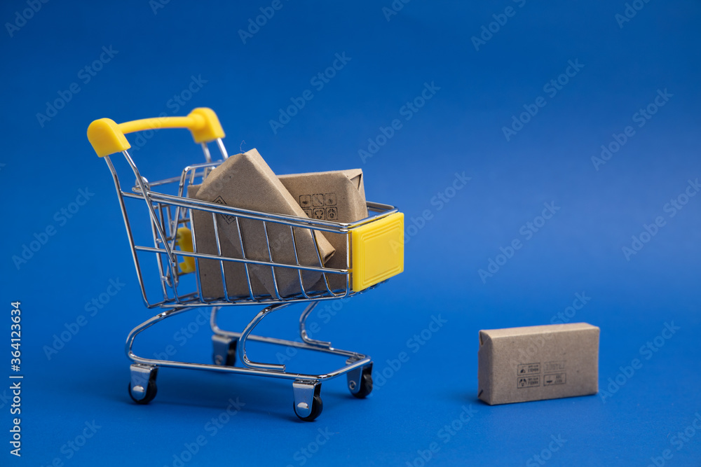 Yellow shopping cart or trolley and small , Product box, Package box ...