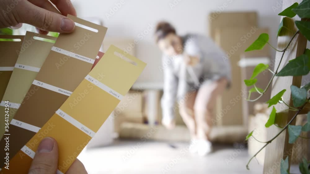 Millennial couple choose wall paint color in our spacious modern home ...