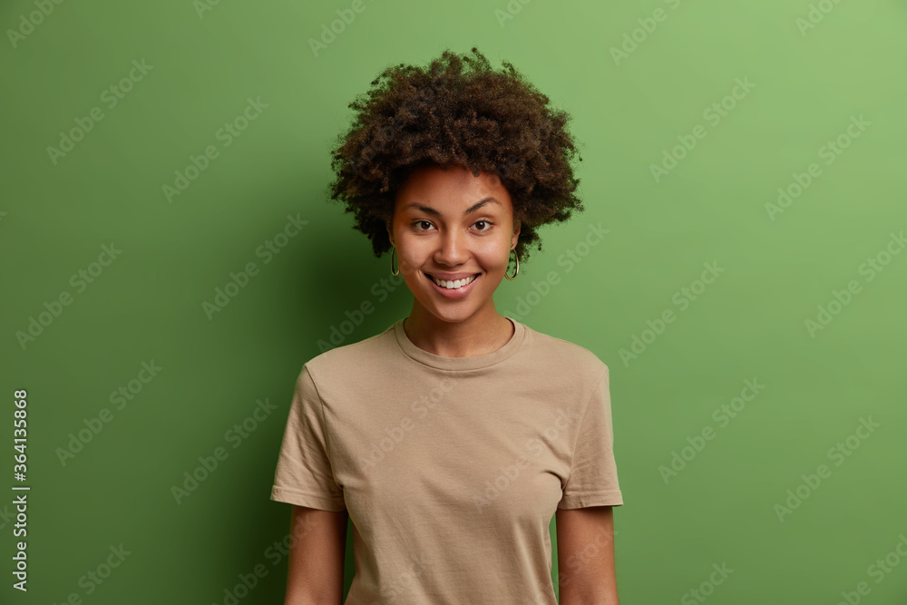 Headshot of cute smiling ethnic woman with Afro hair grins at camera ...