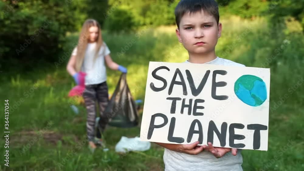 kid child holds save planet ecology poster looking to camera. volunteer ...