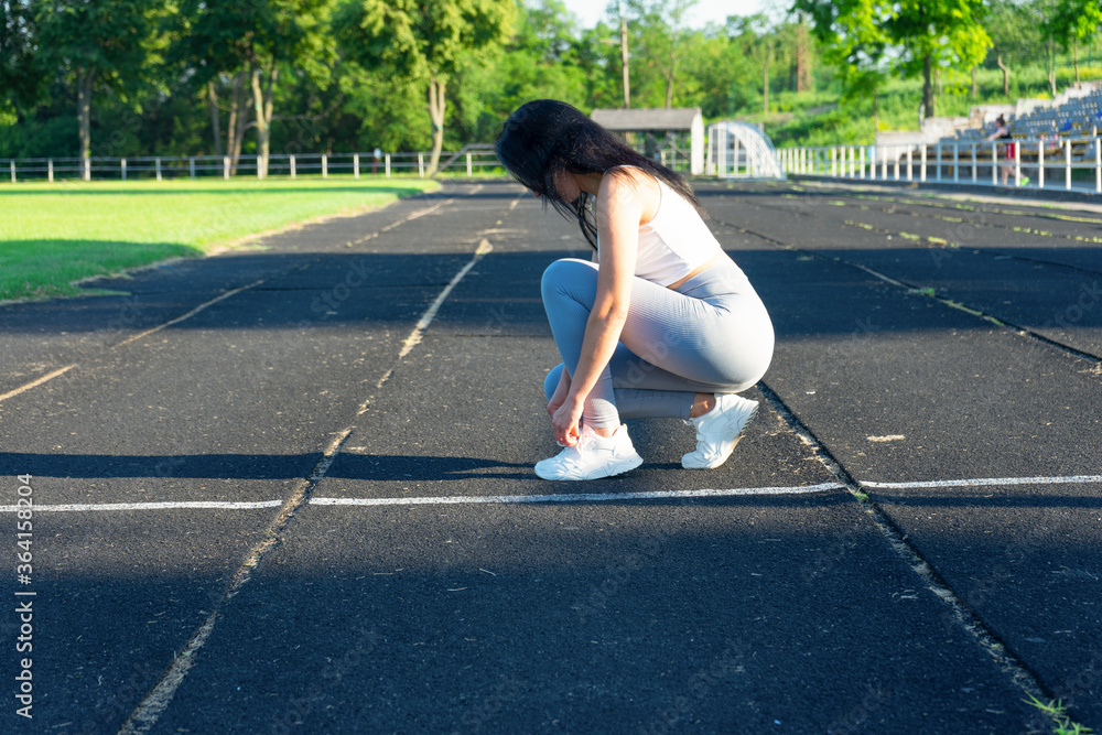 athletic girl jogging at stadium . low start. a head start. fir girl at ...