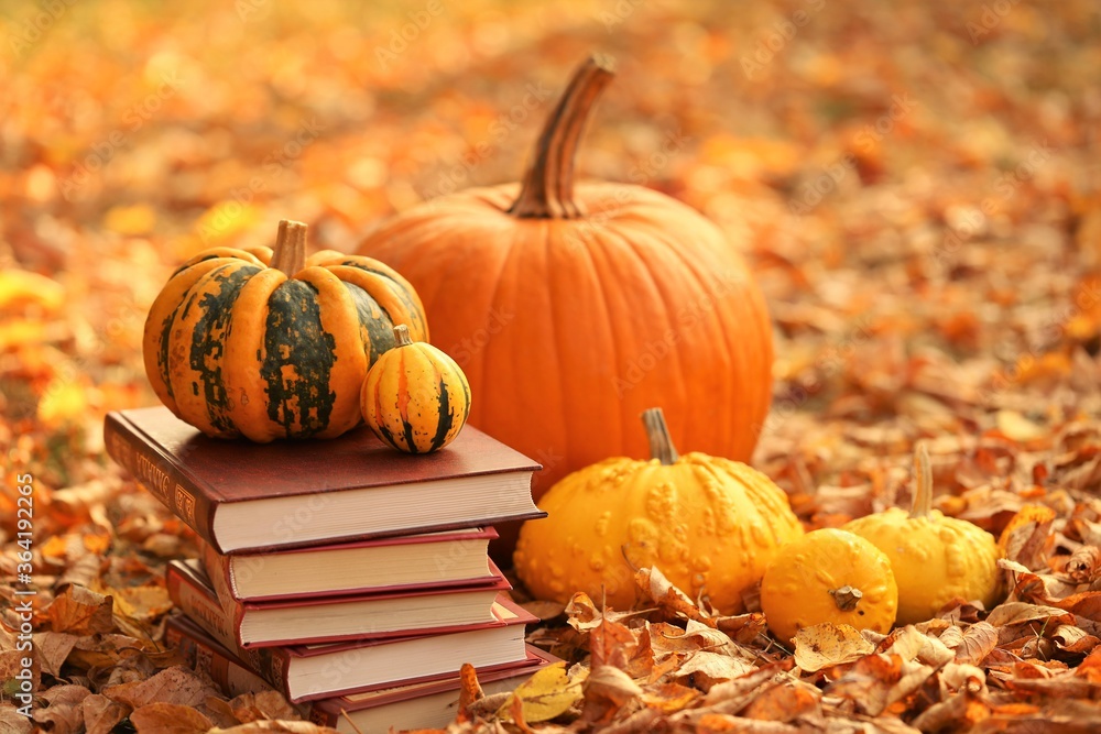 Autumn books. Halloween books. Stack of books and pumpkins set on ...