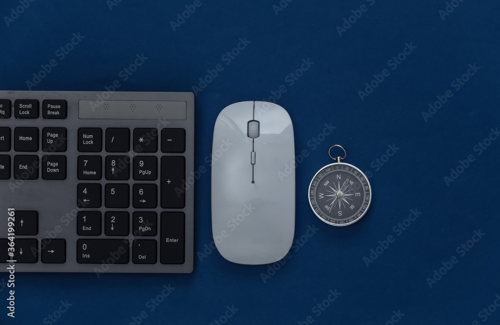 PC keyboard with pc mouse and compass on a classic blue background. Top ...