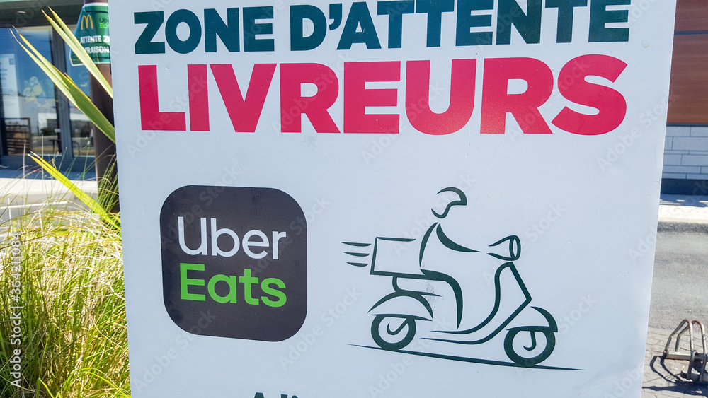 Uber eats sign logo text on board for parked delivery bicycle driver ...