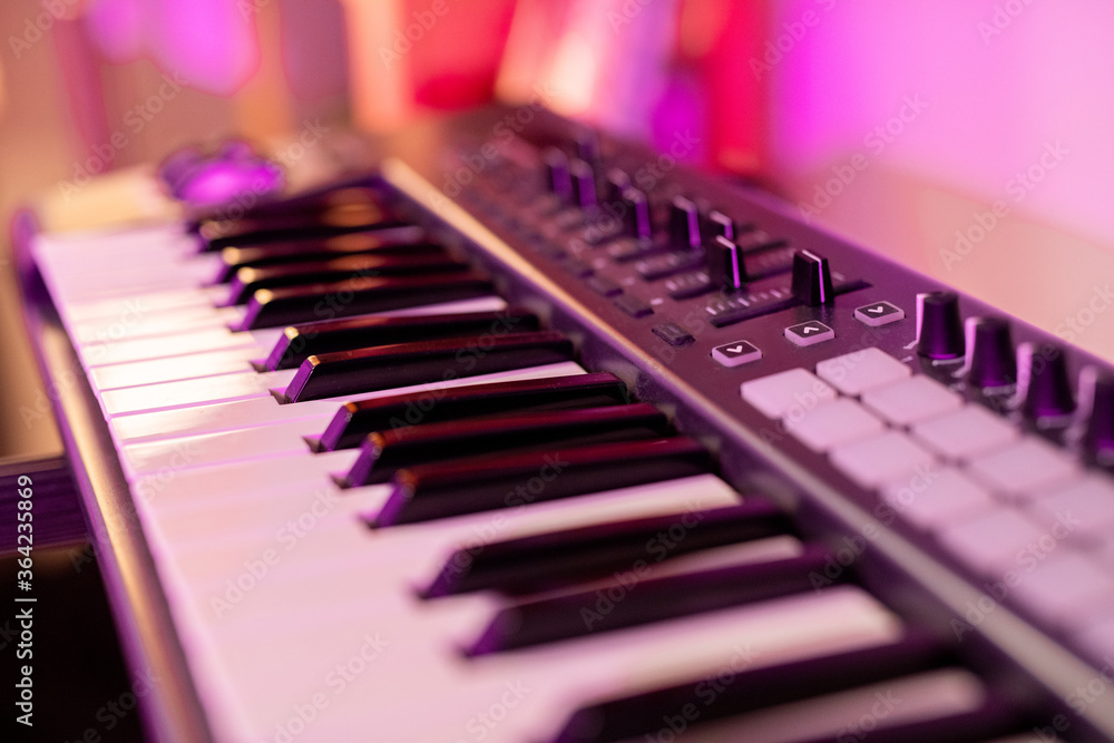 Part of piano keyboard with black and white keys, buttons and many ...