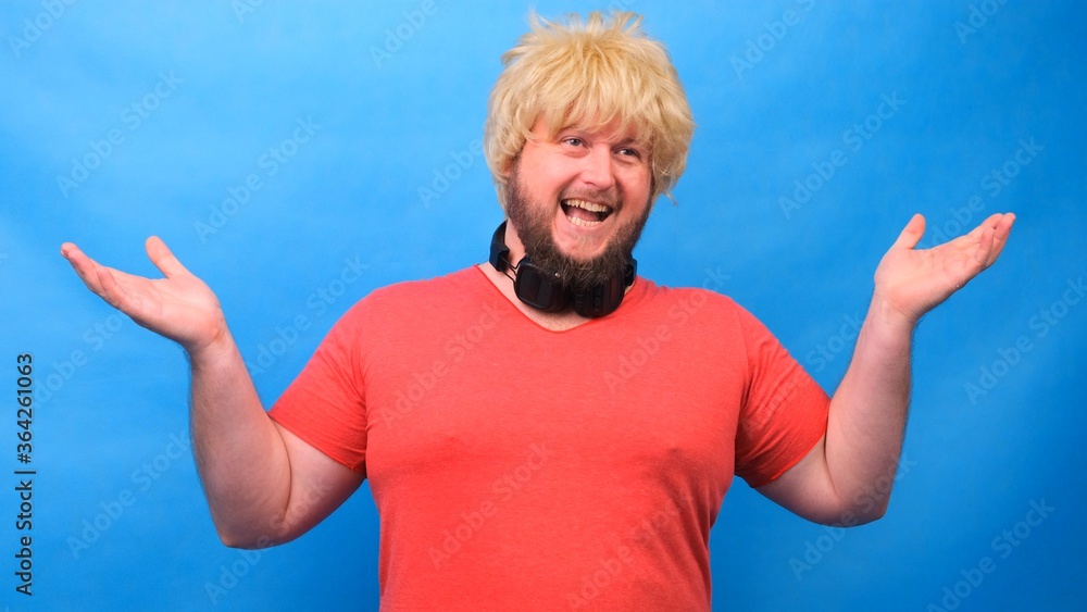 laughing freaky fat man in a wig and a pink T-shirt in his hands ...