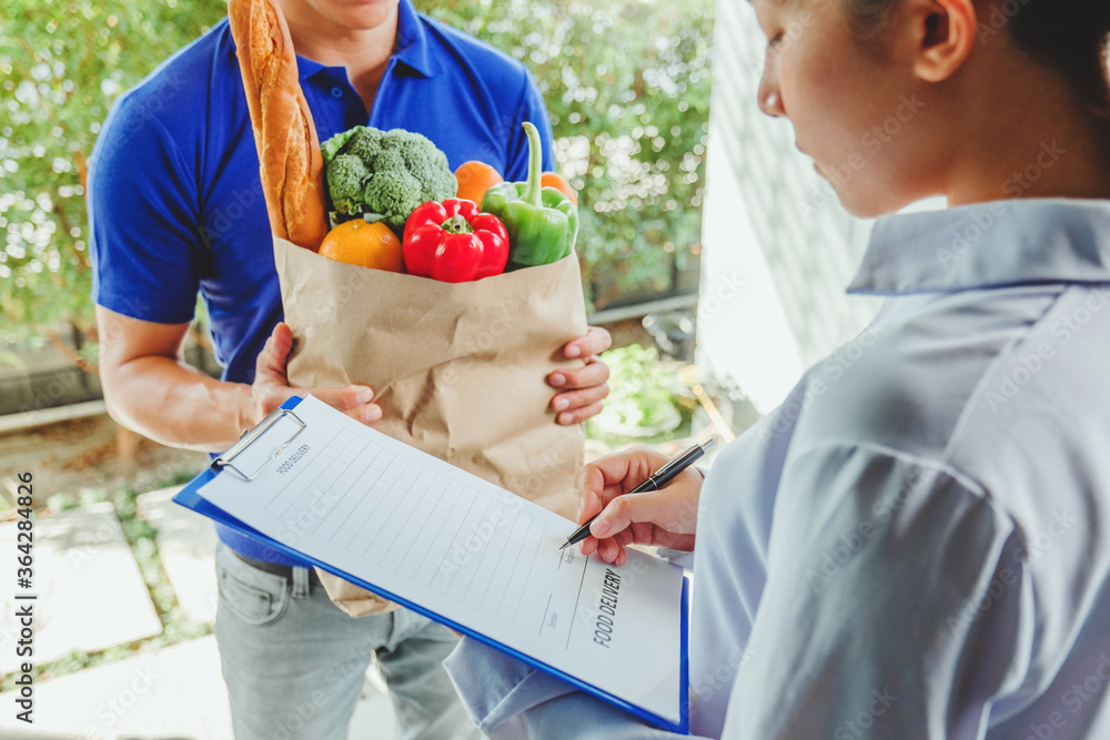 Food Delivery concept. Asian woman hand accepting bag of food, fruit ...
