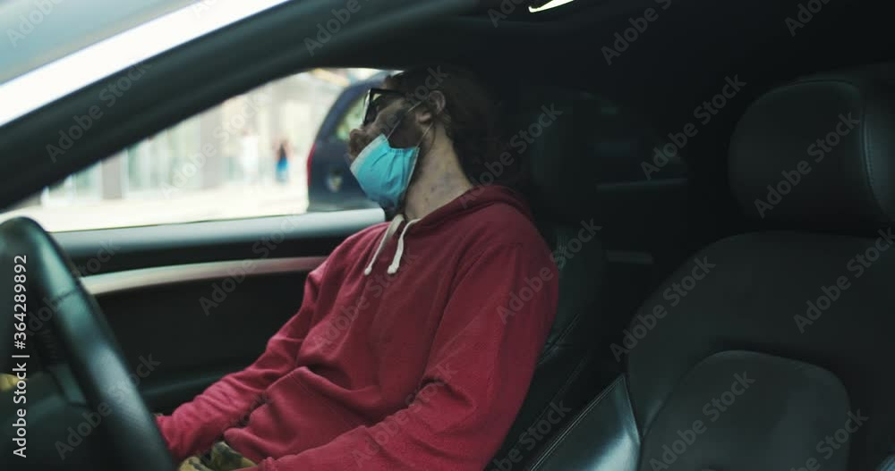 Unsuspecting young man getting into the car while spooky zombie sitting ...