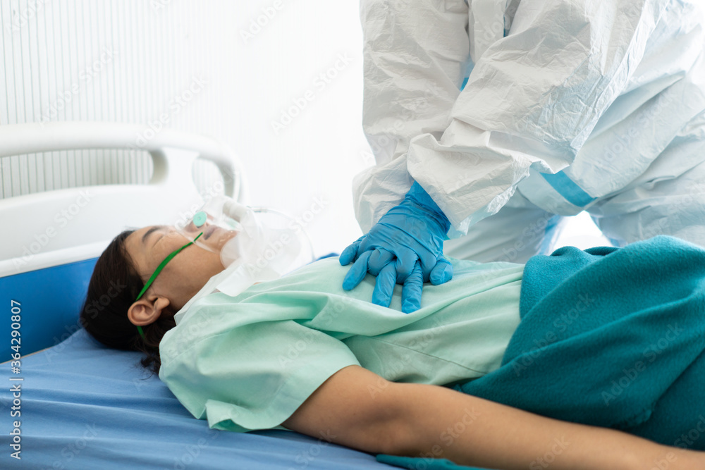 doctor in personal protective equipment or ppe perform chest ...