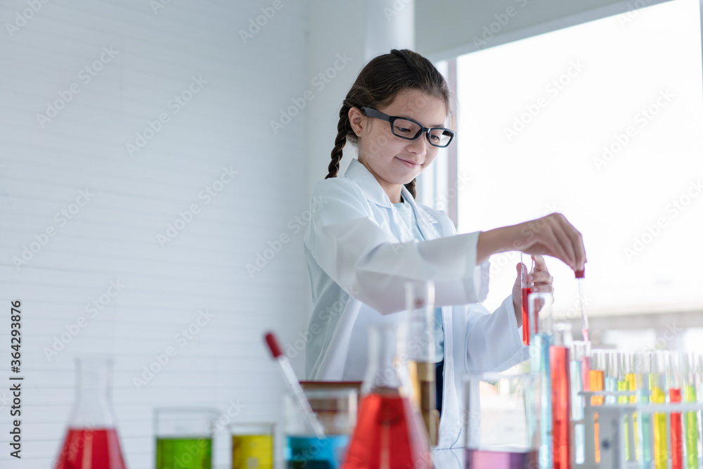 Young girl scientist making experiments chemical in glass tube in the ...