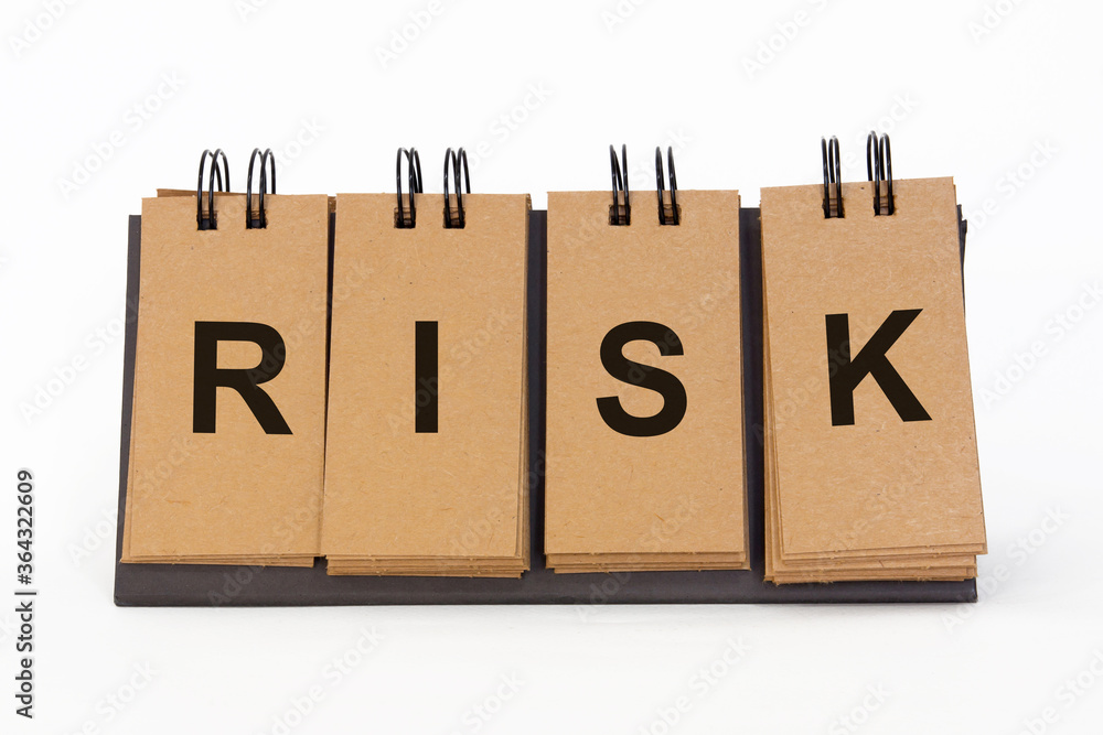 desk standing paper on white background with message RISK , risk ...