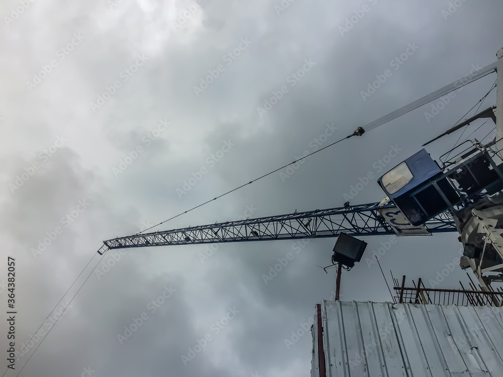 Luffing jib tower crane at high rise building construction site project ...