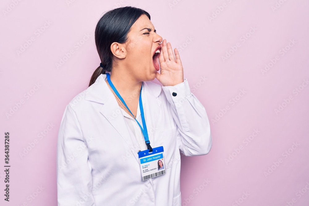 Young beautiful doctor woman wearing stethoscope and id card over ...