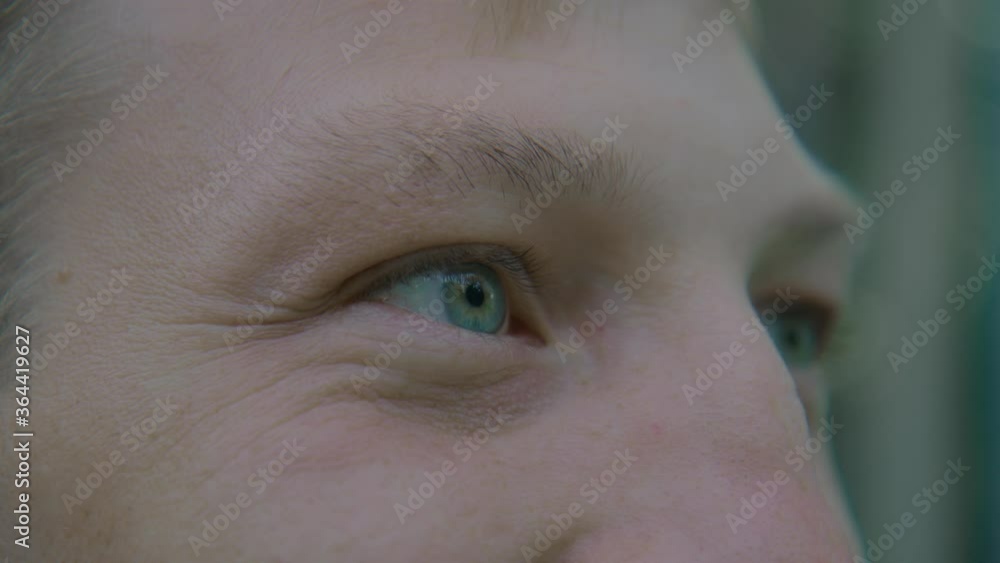 Close-up Portrait of a young man. Blue eyes of a young guy macro ...
