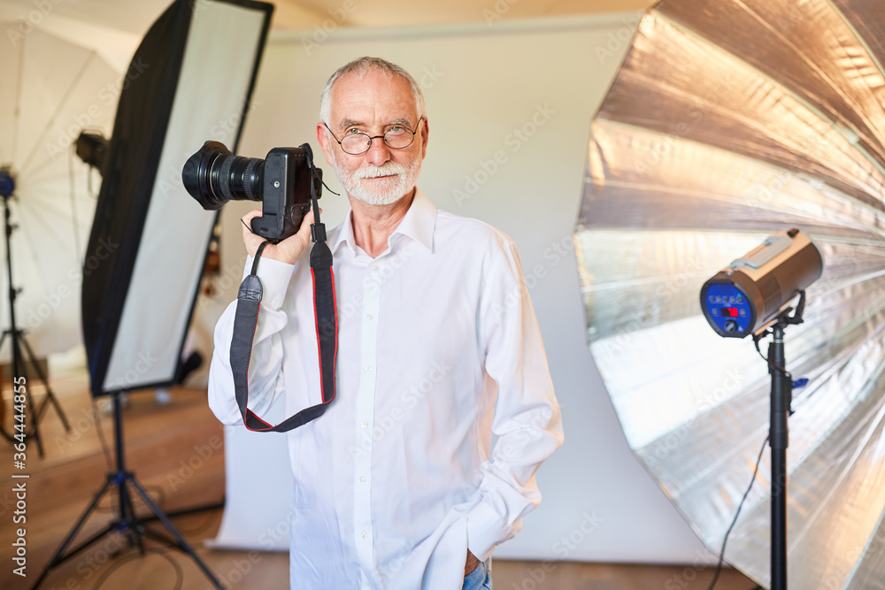 Senior as a professional photographer with camera Stock Photo | Adobe Stock