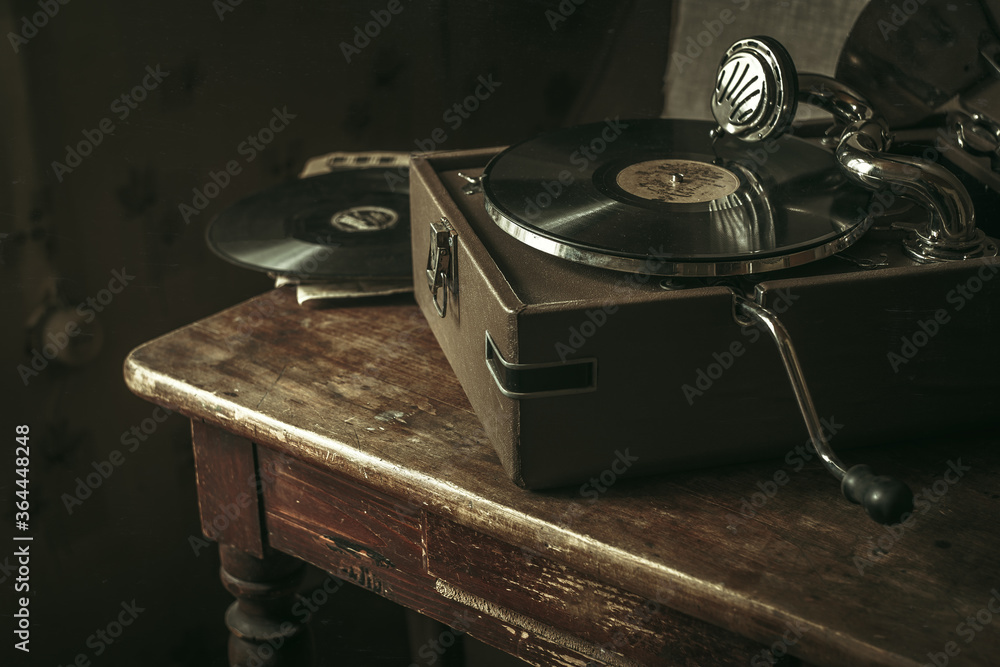 Vintage record player, gramophone on the table, next to the records ...