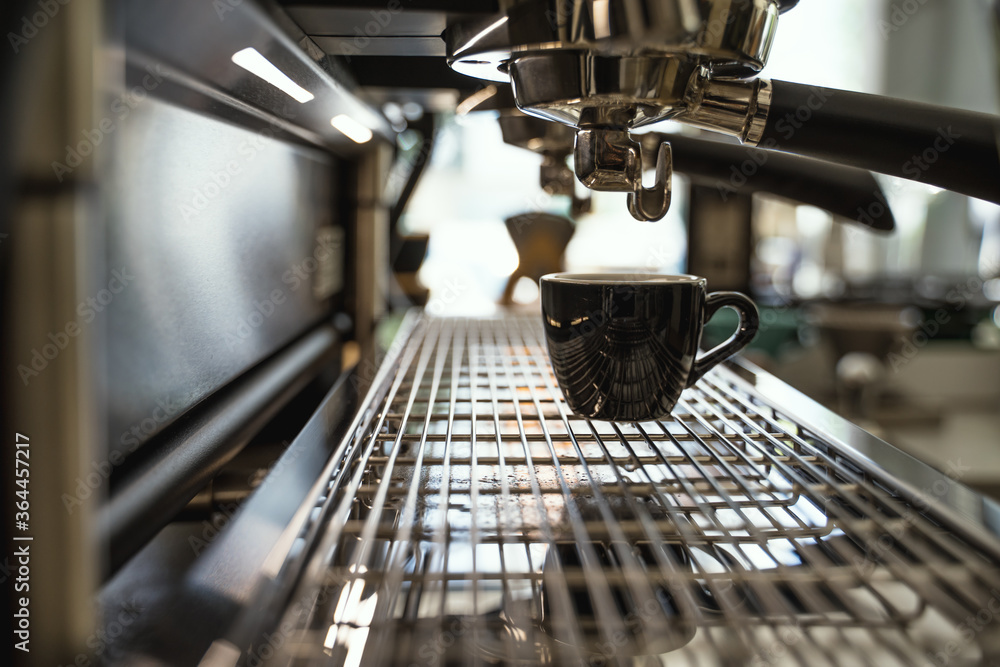 Professional coffee machine pouring espresso. Barista coffee making ...
