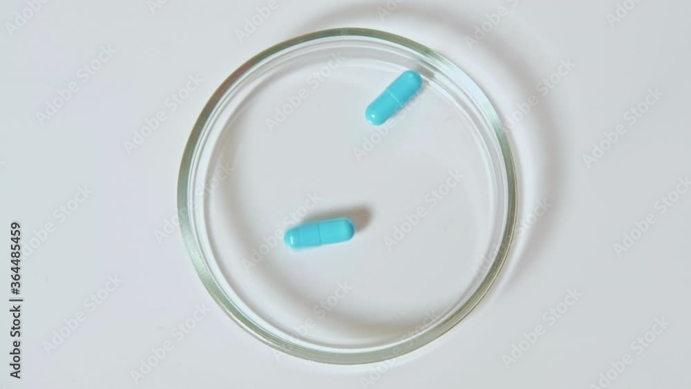 Pharmaceutical test. Medication dosage. Capsules pills falling down in ...