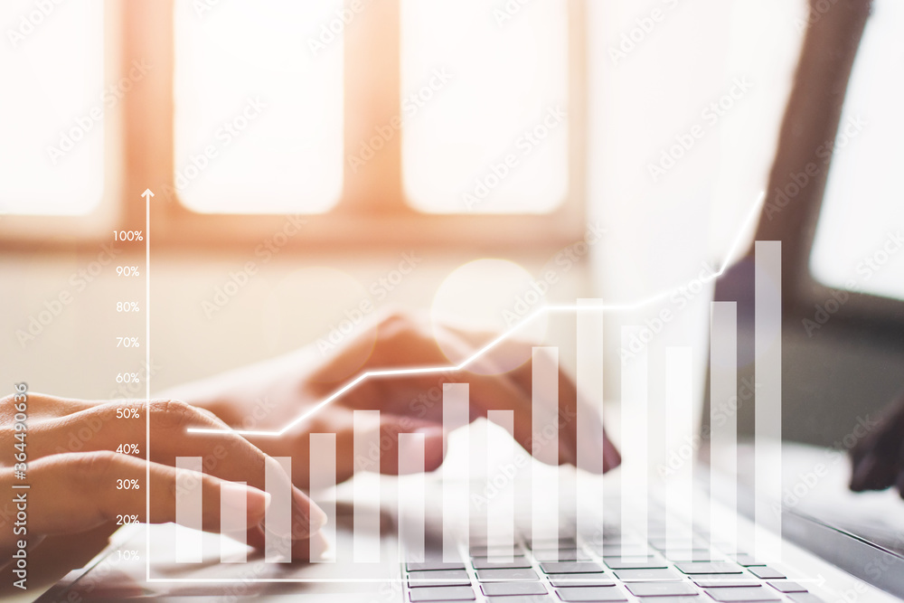 Hand using computer laptop analyzing sales data and economic growth ...