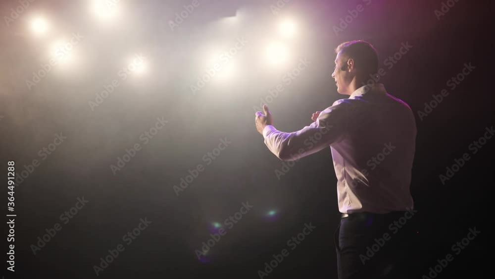 Man stand up comedian speaking jokes in micropphone headset standing on ...
