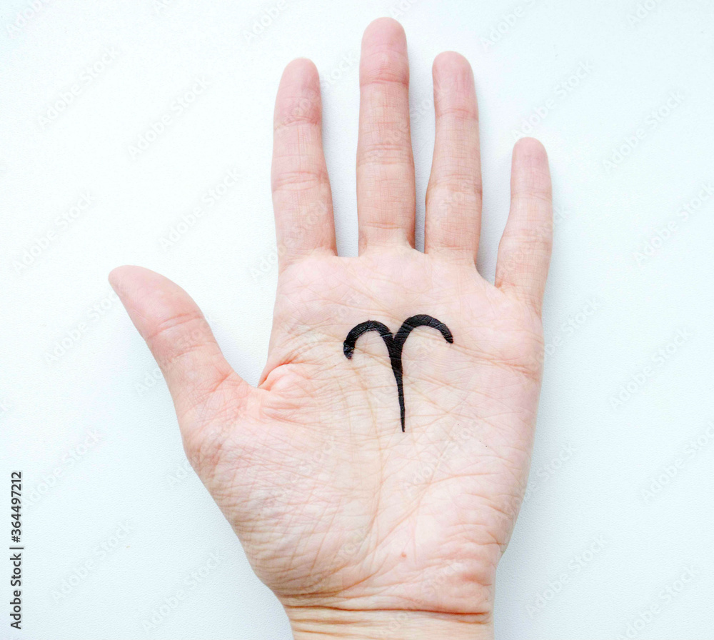 On the palm of a young girl with a black felt-tip pen is drawn the ...