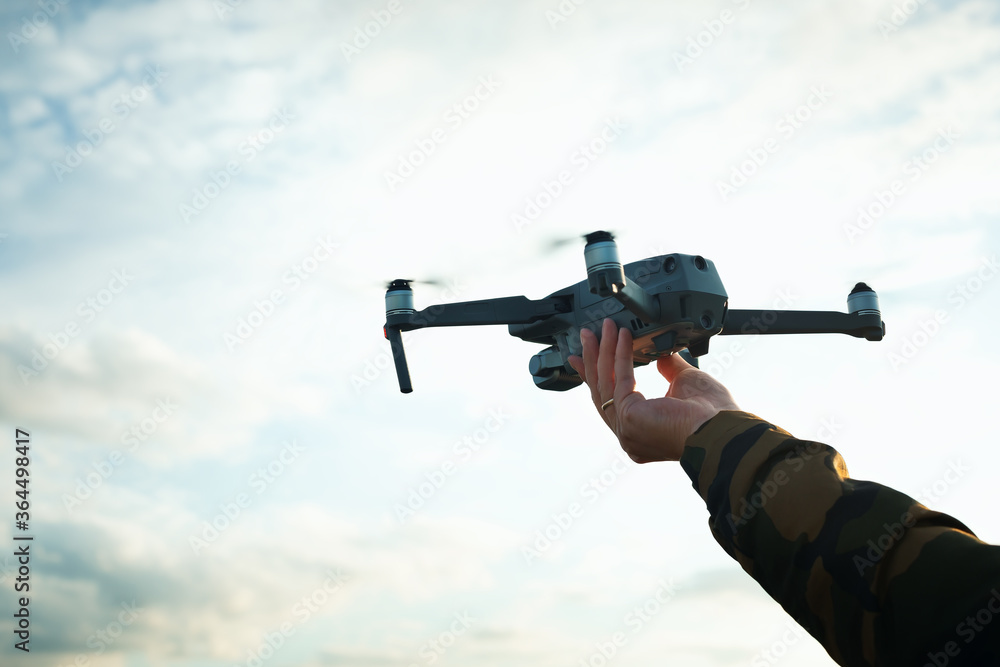 drone floating above hand ready to land, Stock Photo | Adobe Stock
