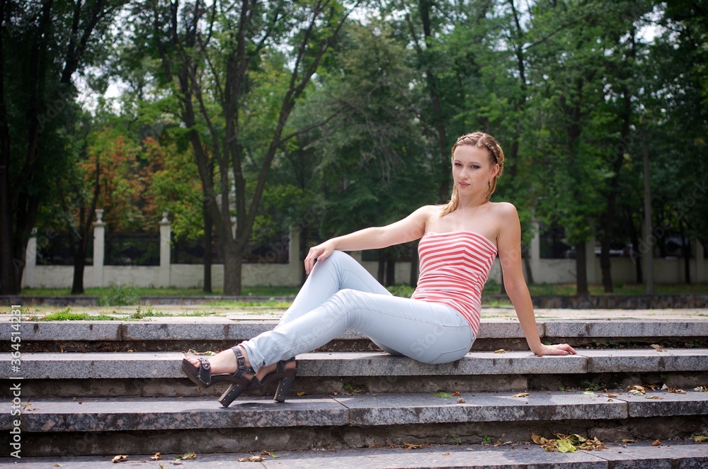The beautiful girl is walking outdoors. Girl in the park. Girl on ...