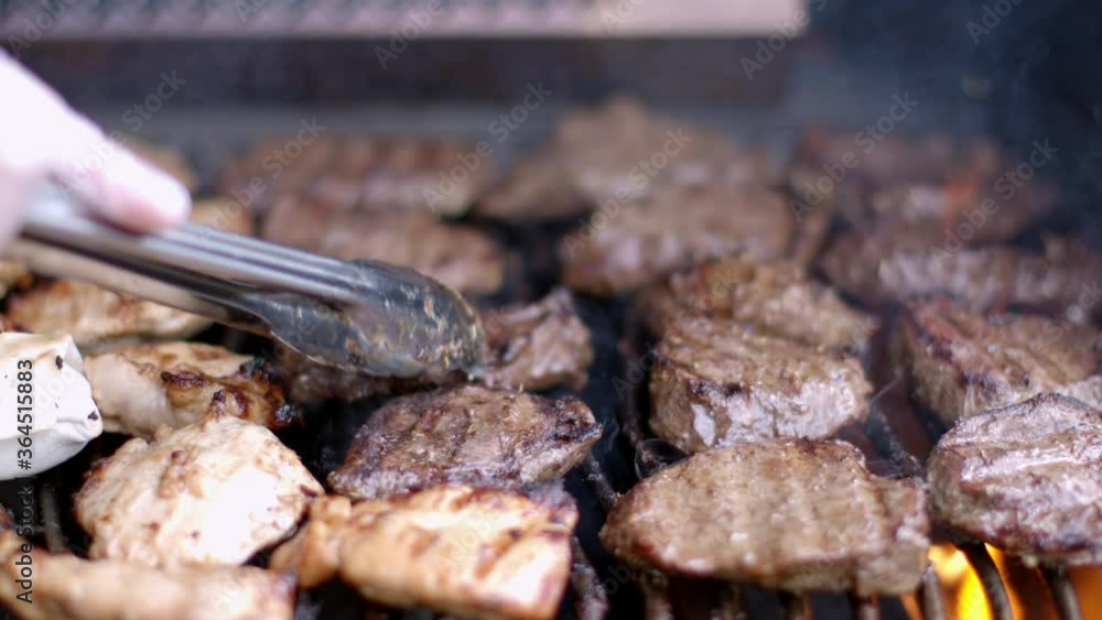 Close up view of cooking grilled meat on charcoal fire, roast pork on ...