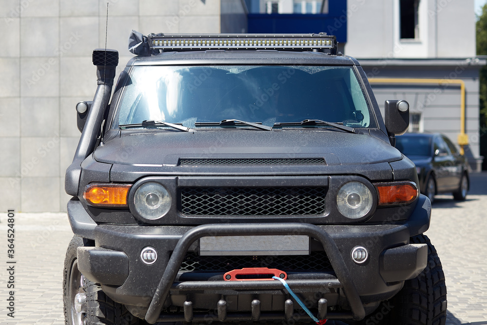 Front window of black car parked on the street in summer sunny day ...