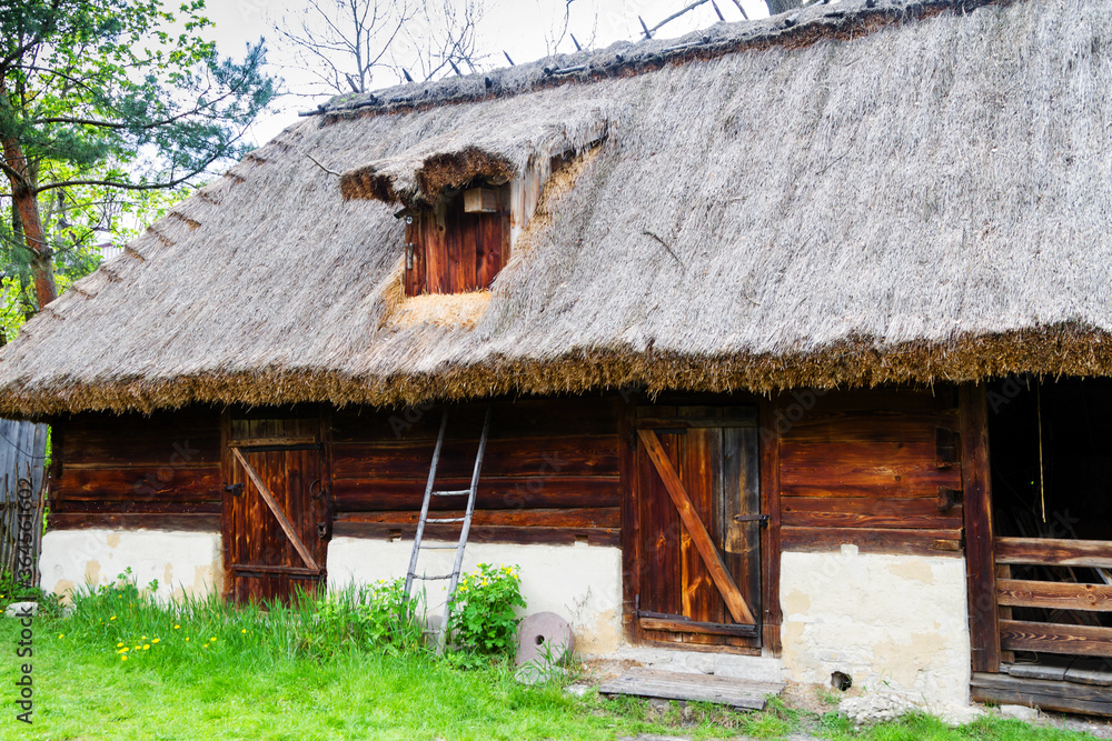 GUCIOW, POLAND - MAY 3, 2016: Old log cabin in an open-air ethnography ...